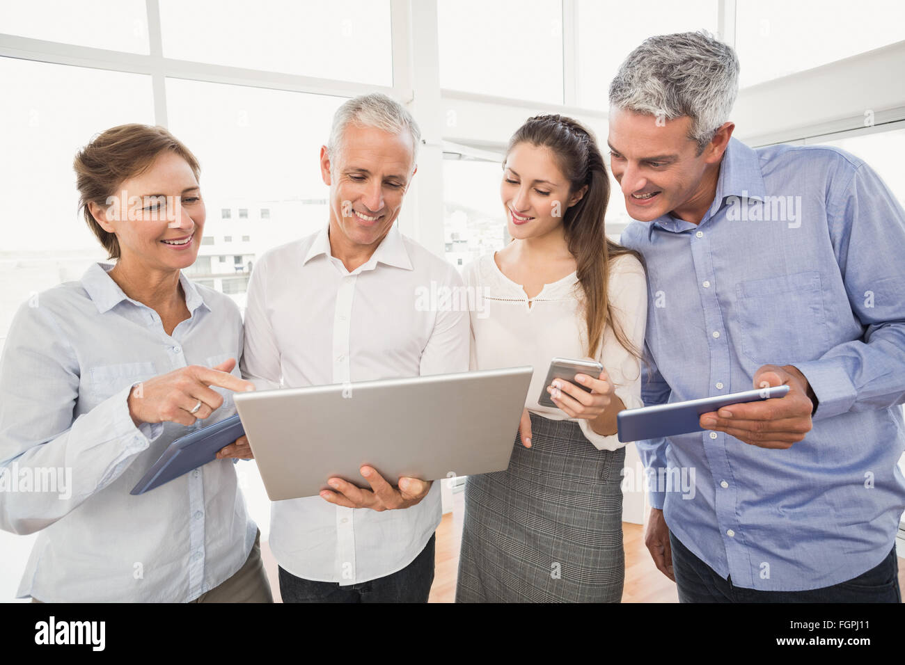 Business people using several electronic devices Stock Photo - Alamy
