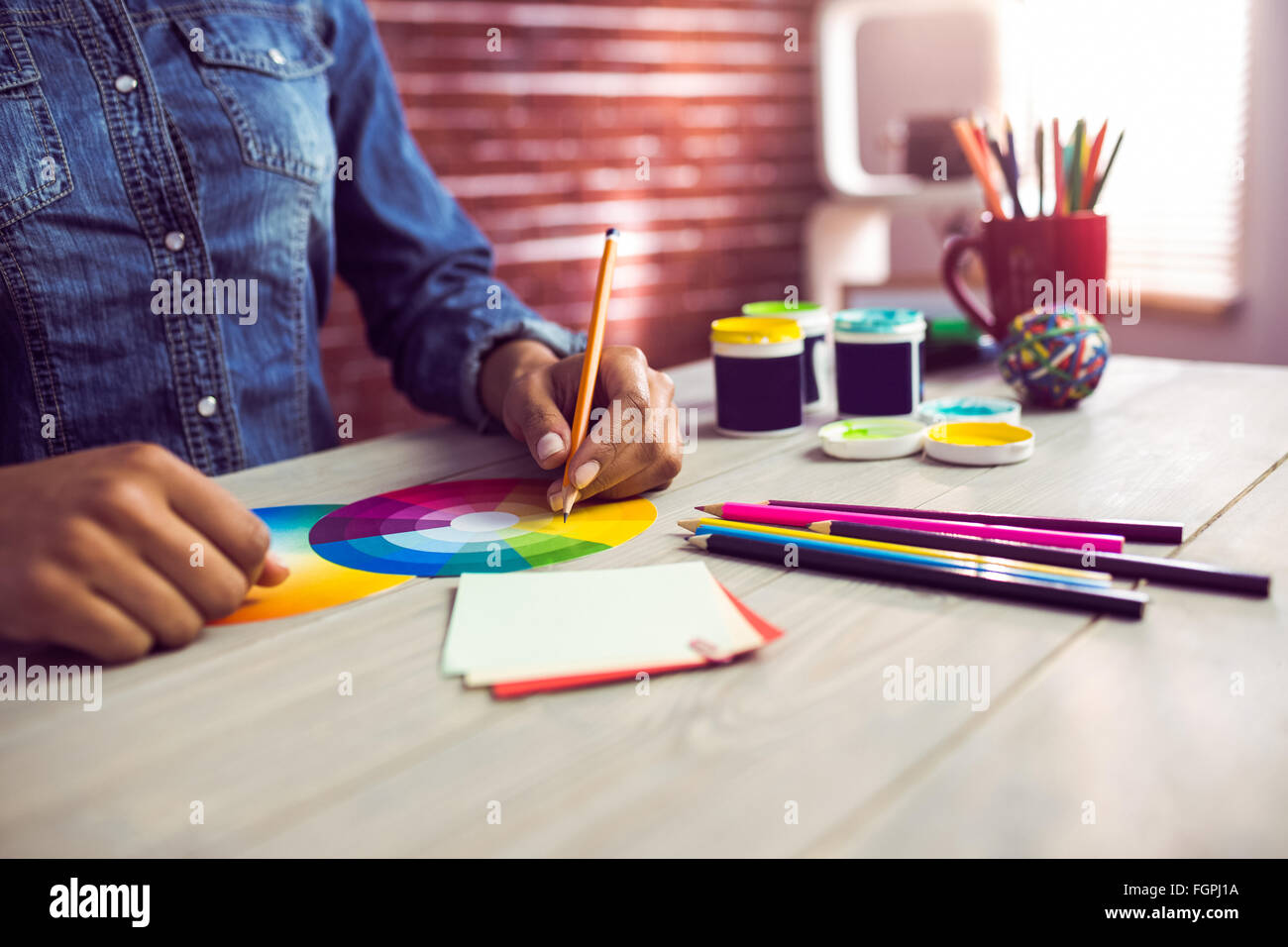 Graphic designer drawing on colour chart Stock Photo - Alamy