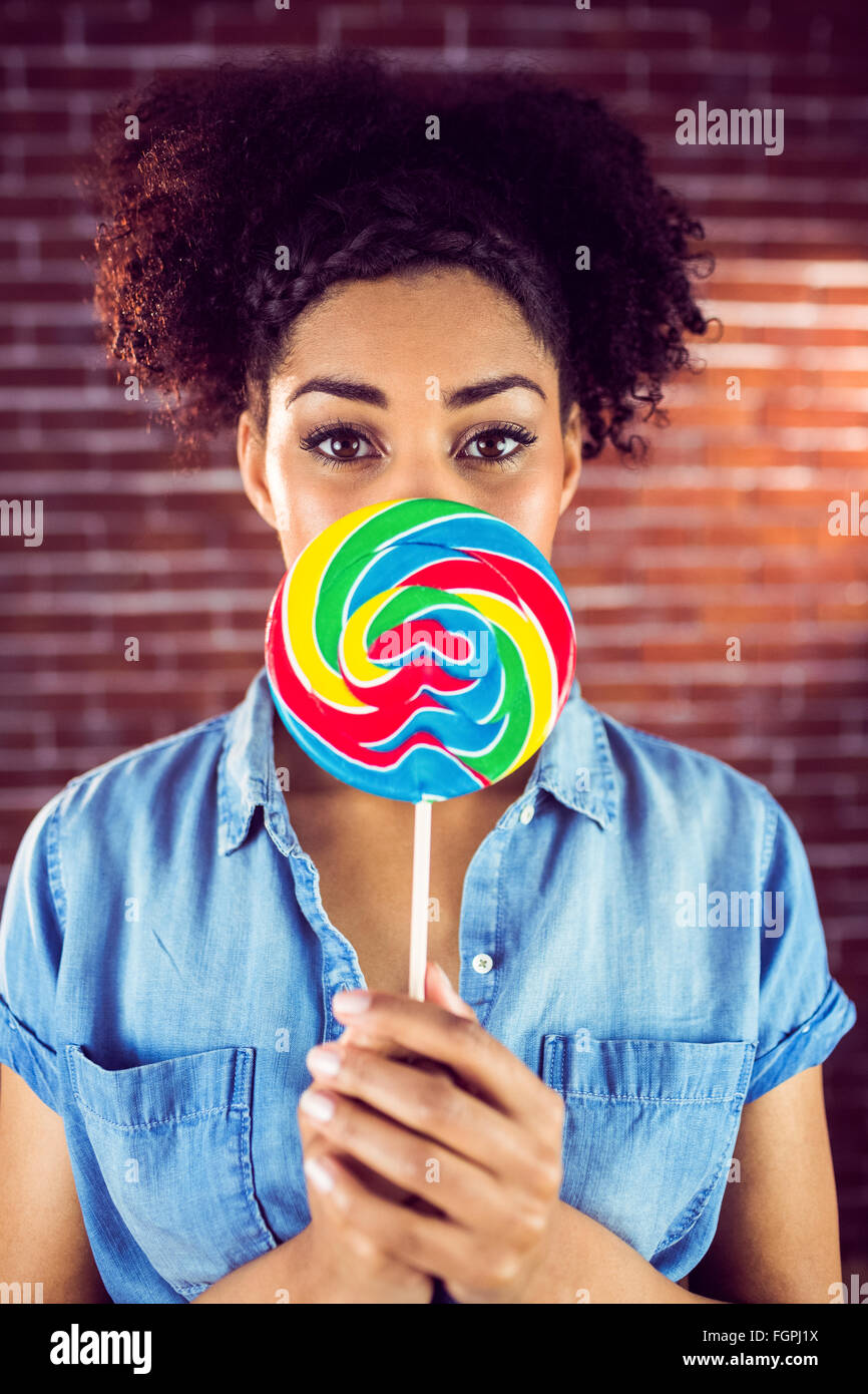 Portrait of a beautiful woman holding a giant lollipop Stock Photo - Alamy