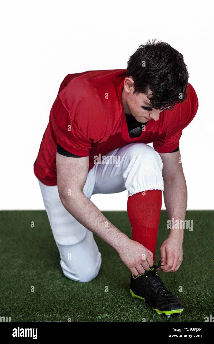 American football player tying his shoelaces Stock Photo - Alamy