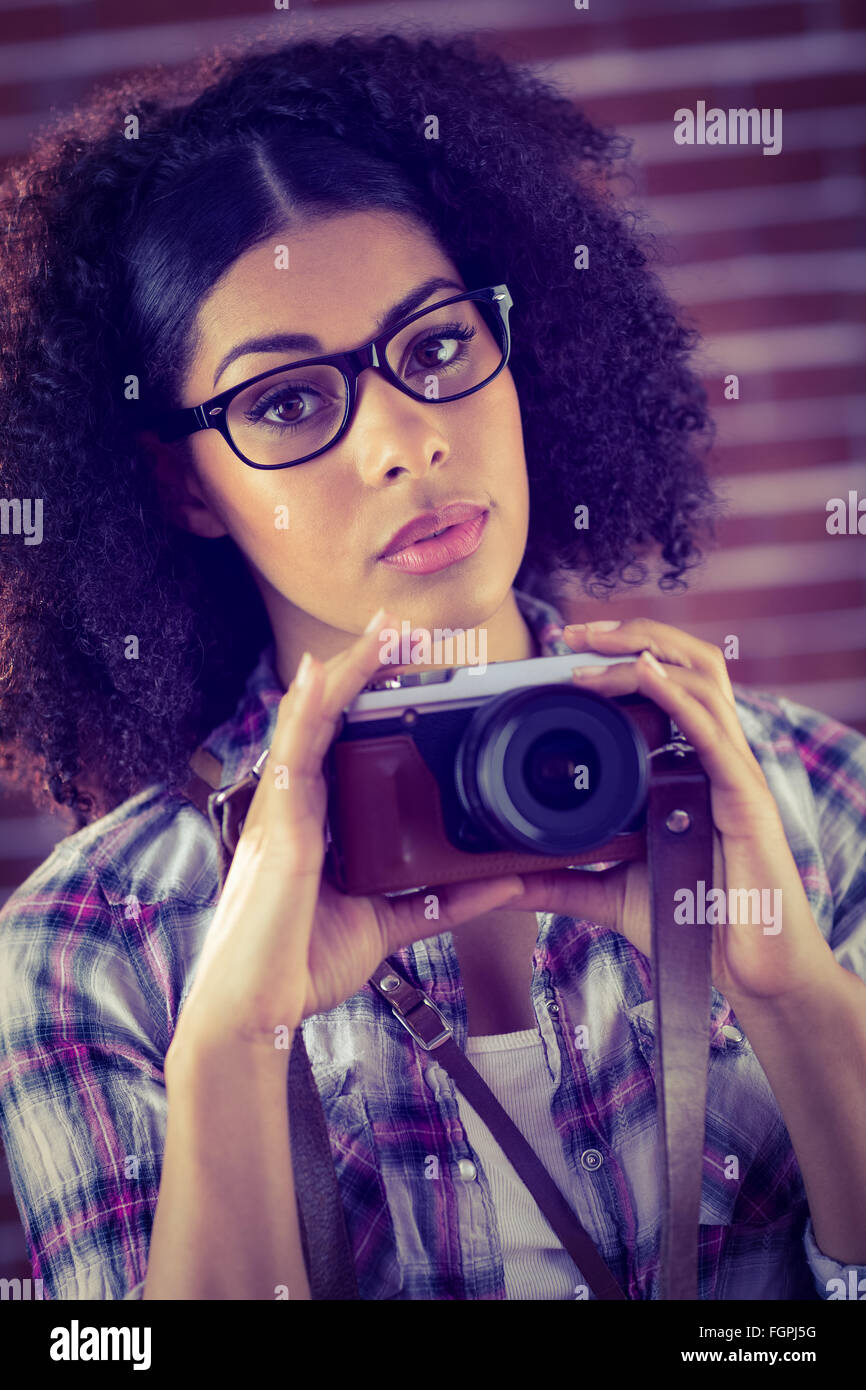 Attractive hipster holding camera Stock Photo - Alamy