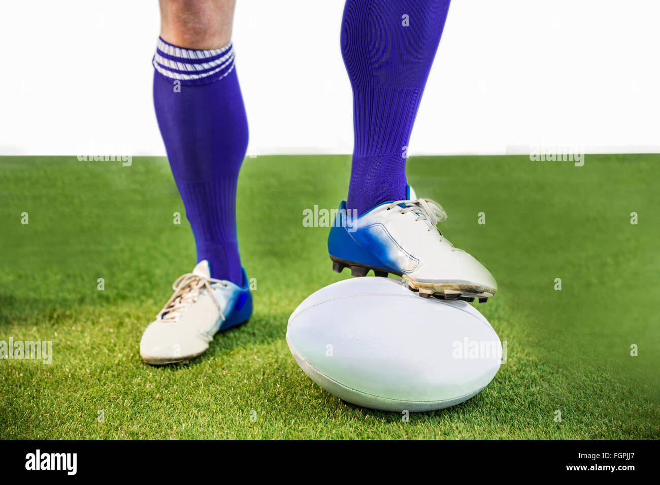 Rugby player posing feet on the ball Stock Photo - Alamy