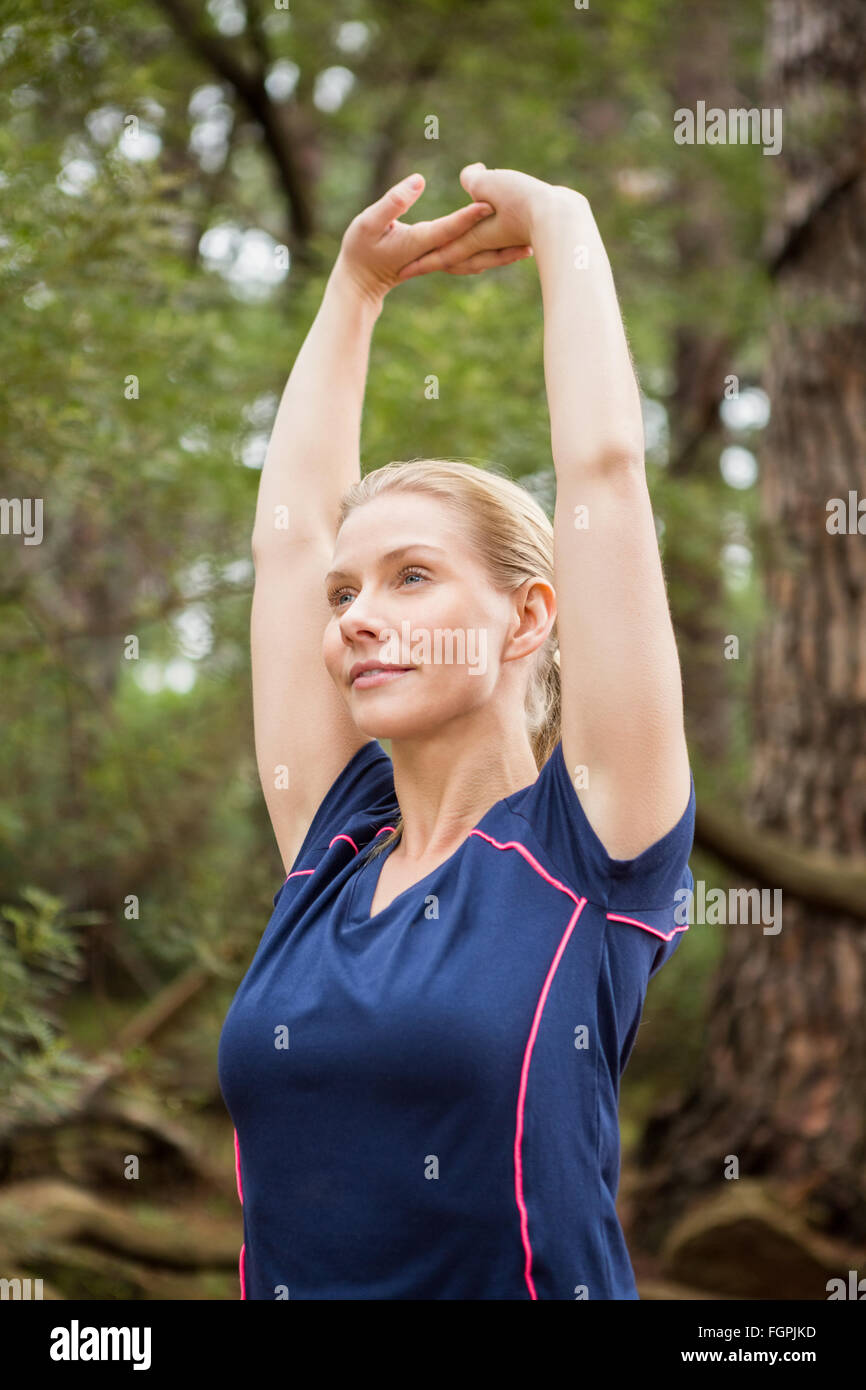 Athletic woman doing arms stretching Stock Photo - Alamy