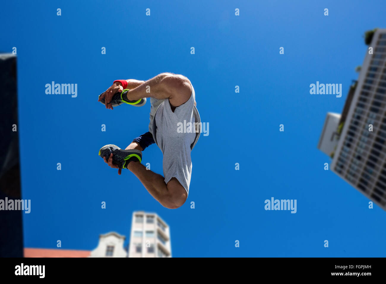 Extreme athlete jumping in the air in front of a building Stock Photo ...
