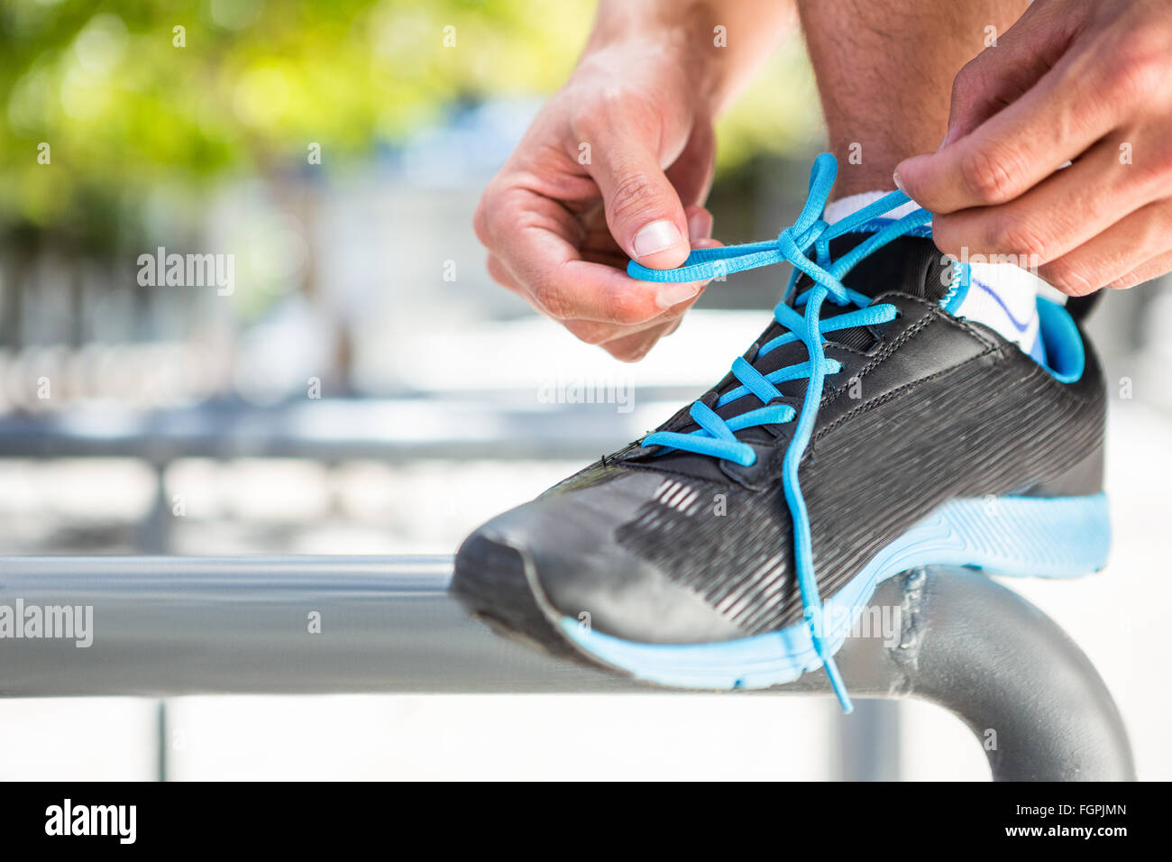 Athlete tying his shoes Stock Photo - Alamy