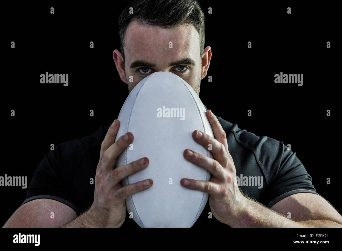 Tough rugby player holding ball Stock Photo - Alamy