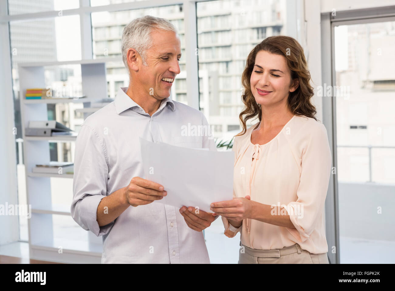 Casual business colleagues looking at documents Stock Photo - Alamy