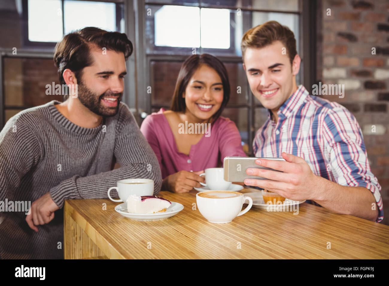 Group of friends looking at a smartphone Stock Photo - Alamy
