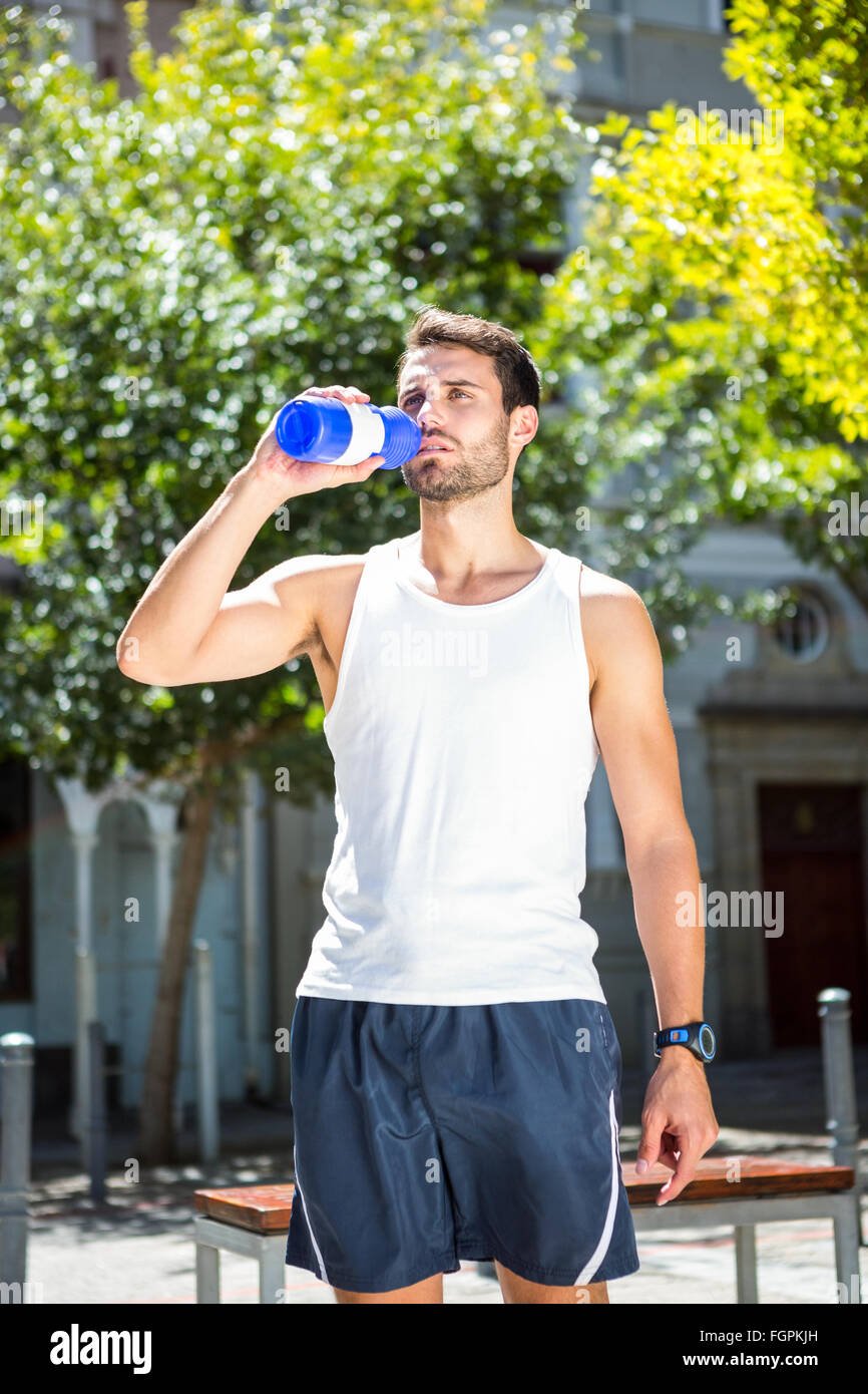 Handsome athlete drinking out of bottle Stock Photo - Alamy