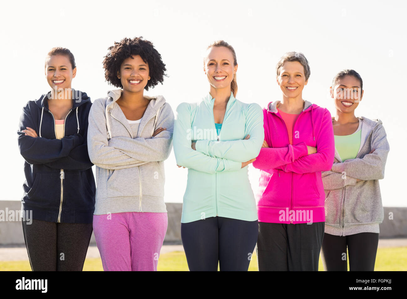 Smiling sporty women with arms crossed Stock Photo - Alamy