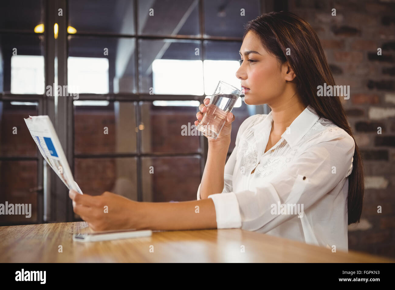 Casual businesswoman looking at files Stock Photo - Alamy