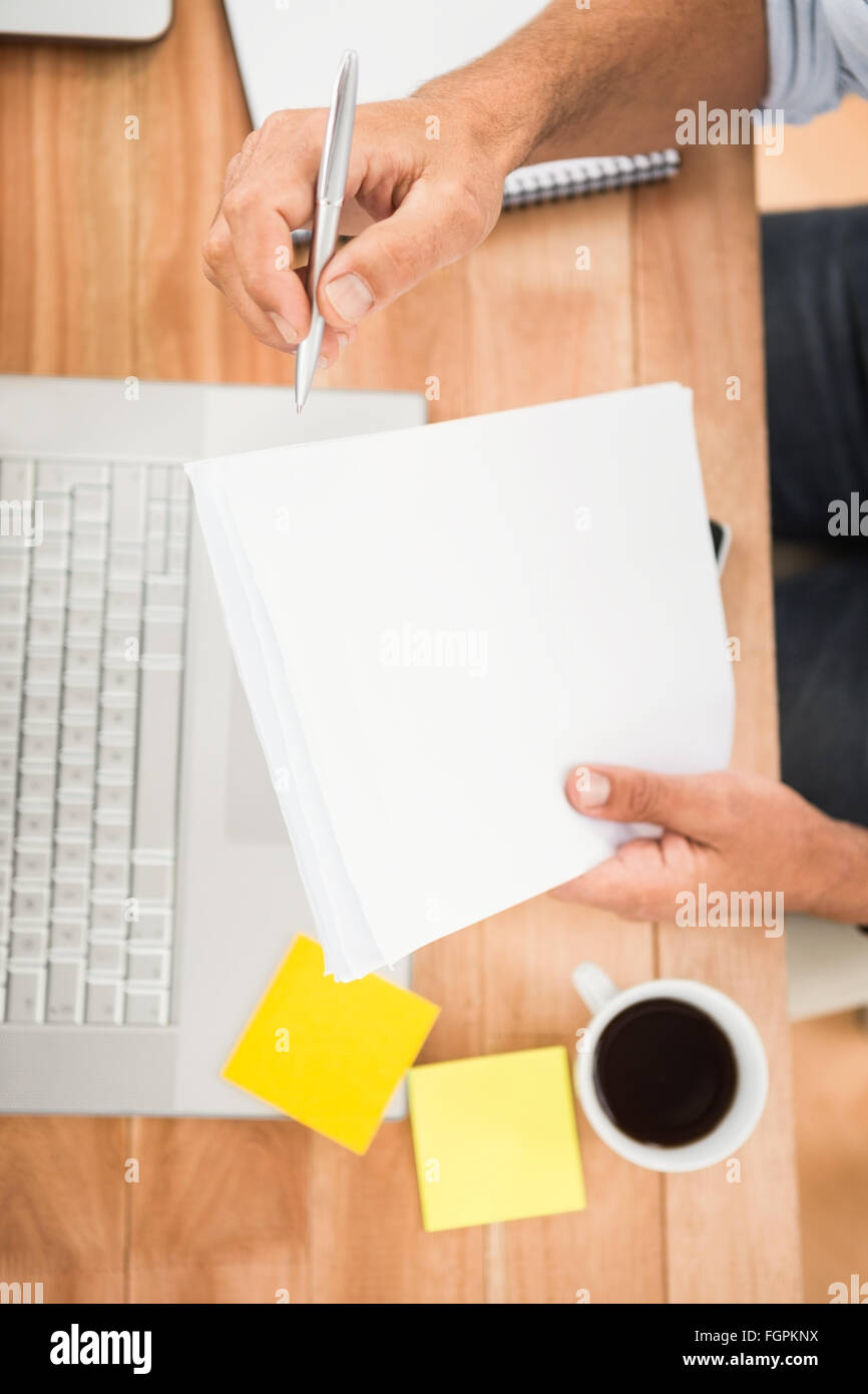 Hands holding notepad over wooden desk Stock Photo - Alamy