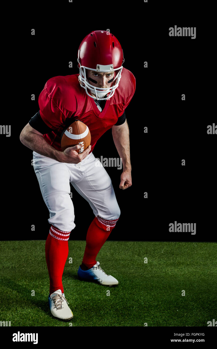 Portrait of focused american football player being ready to attack ...