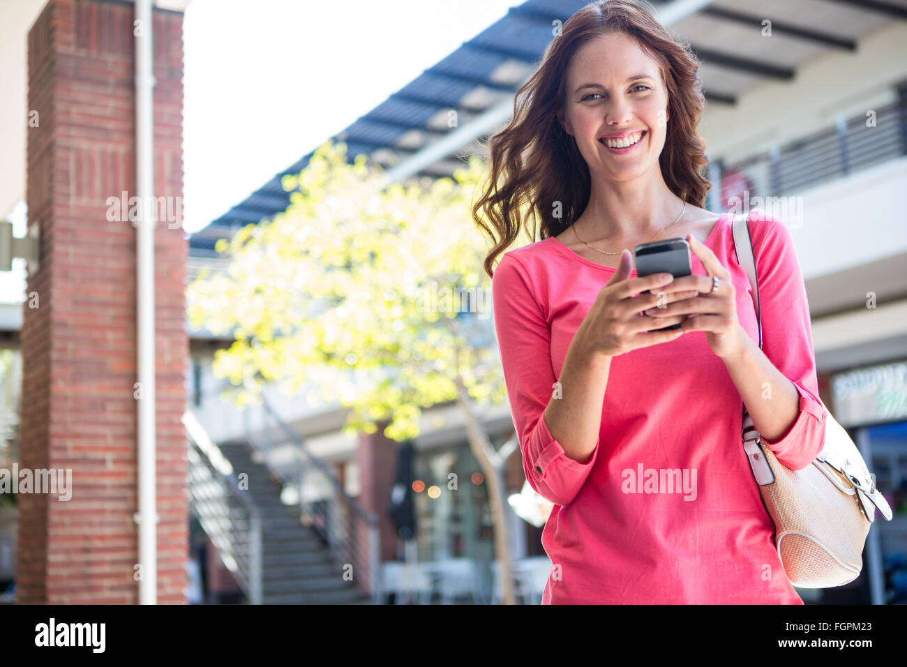 Pretty woman texting at the mall Stock Photo - Alamy