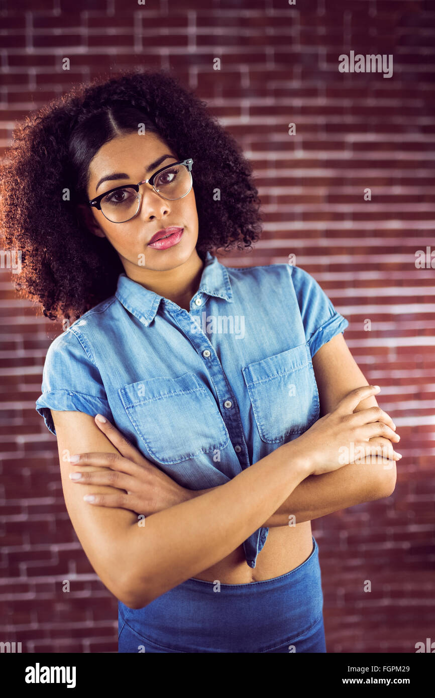 Attractive hipster posing with arms crossed Stock Photo - Alamy