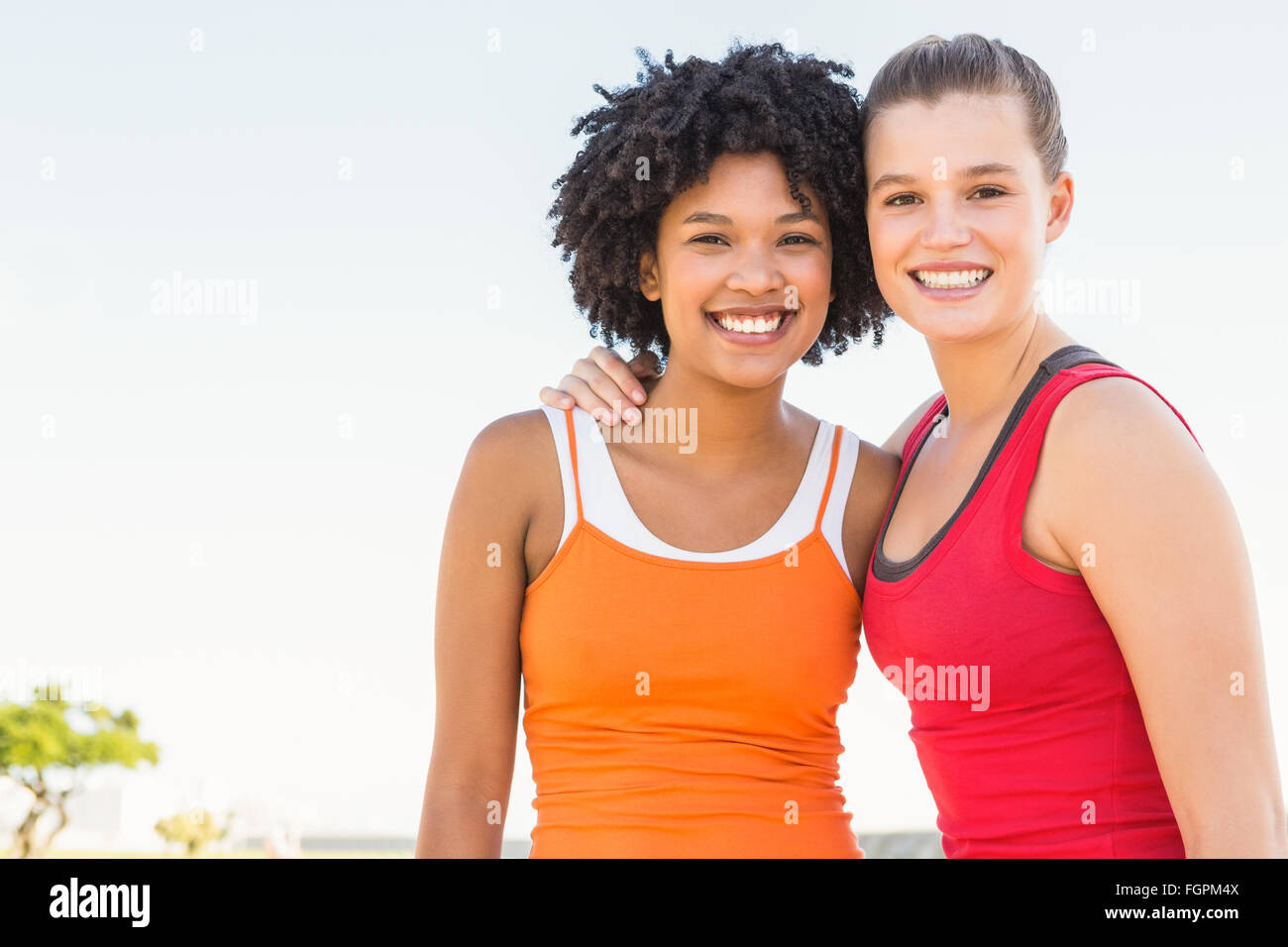 Two young women smiling at camera Stock Photo - Alamy
