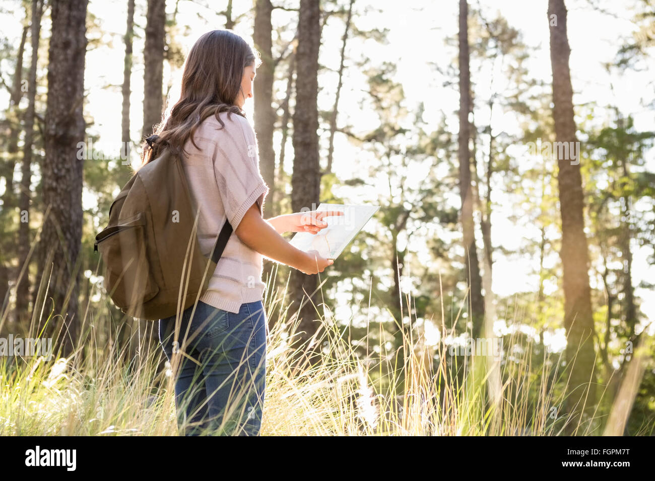 Brunette hiker reading map Stock Photo - Alamy