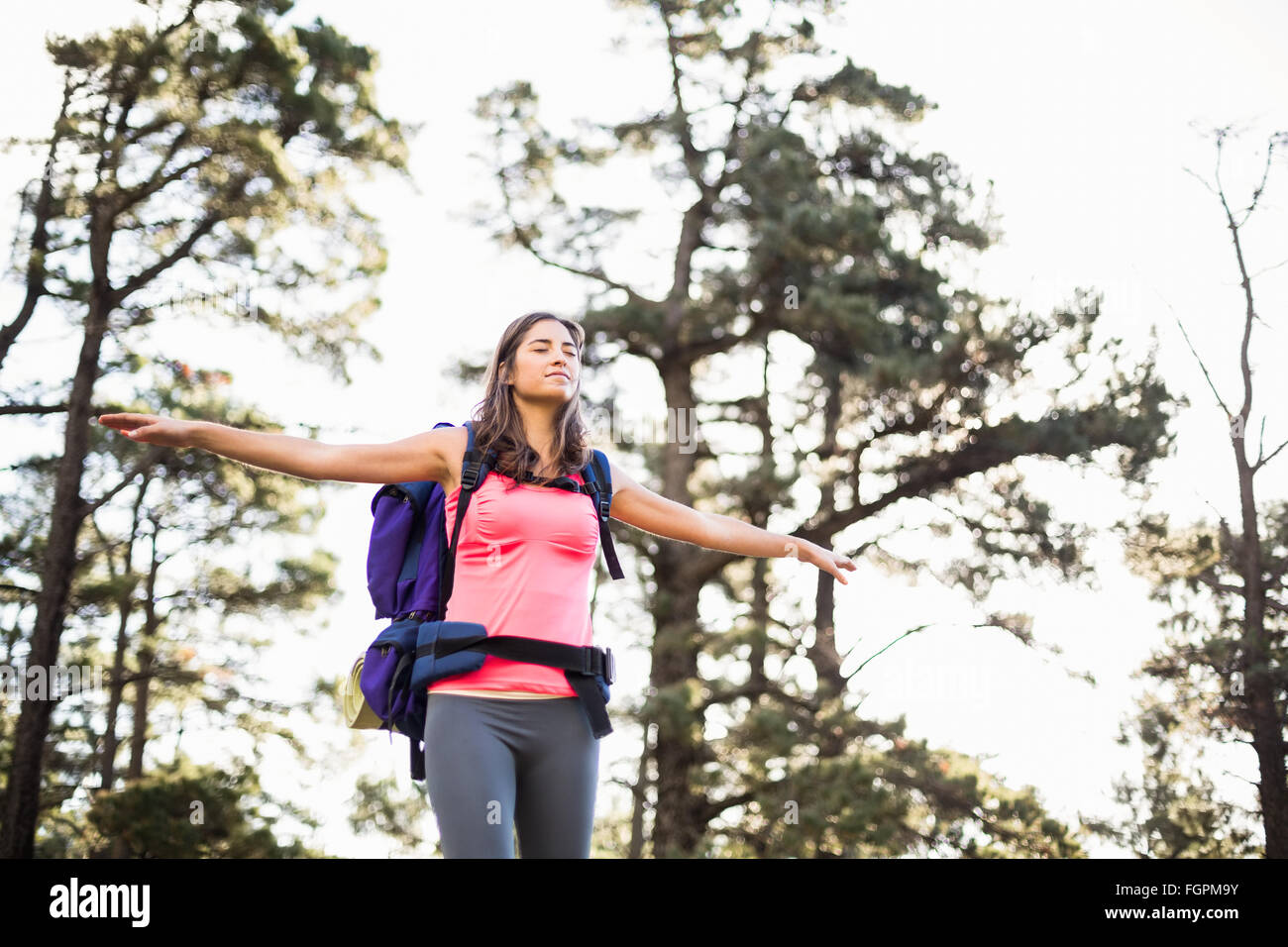 Young happy jogger standing on rock feeling free Stock Photo - Alamy