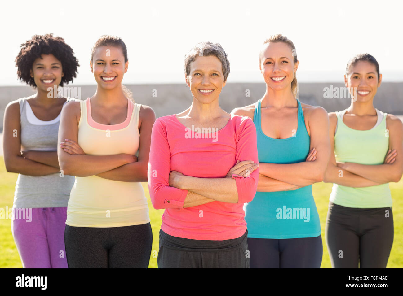 Smiling sporty women with arms crossed Stock Photo - Alamy