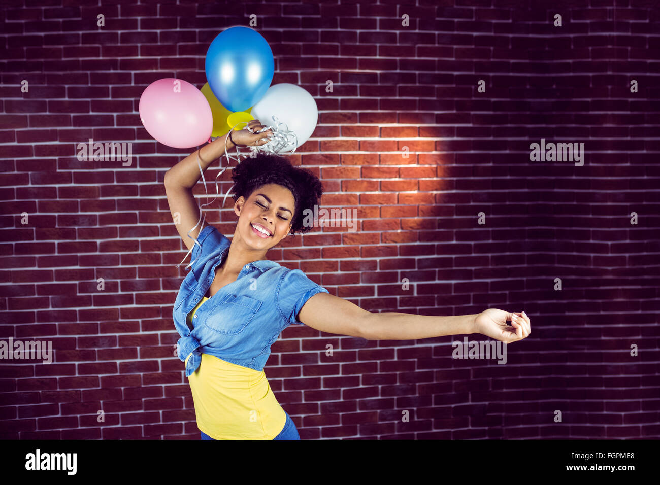 Young woman dancing with balloons Stock Photo - Alamy