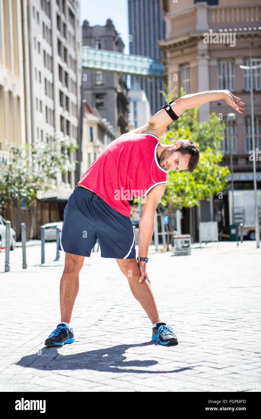 Handsome athlete doing arms stretching Stock Photo - Alamy
