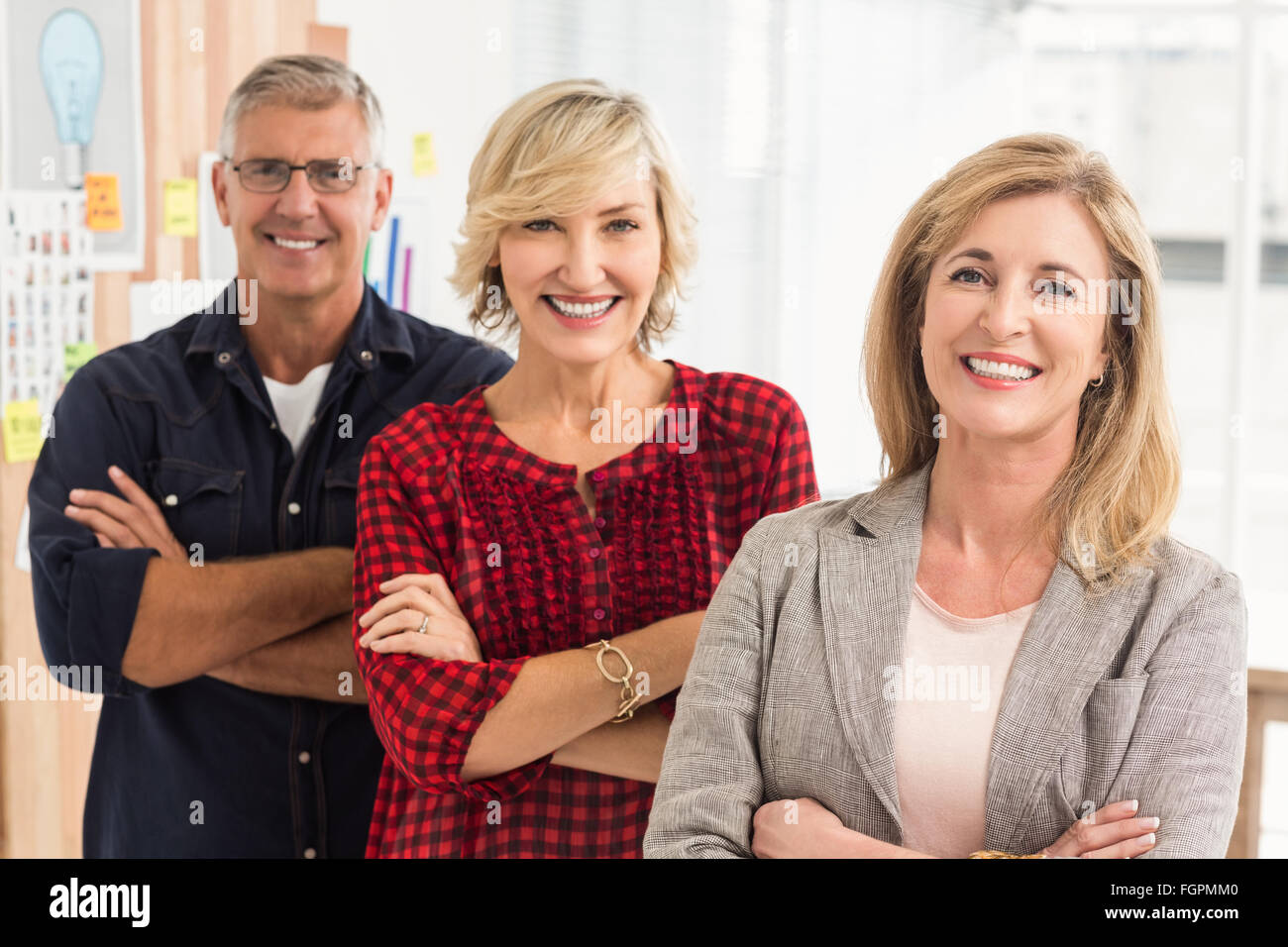 Smiling business team looking at the camera Stock Photo - Alamy