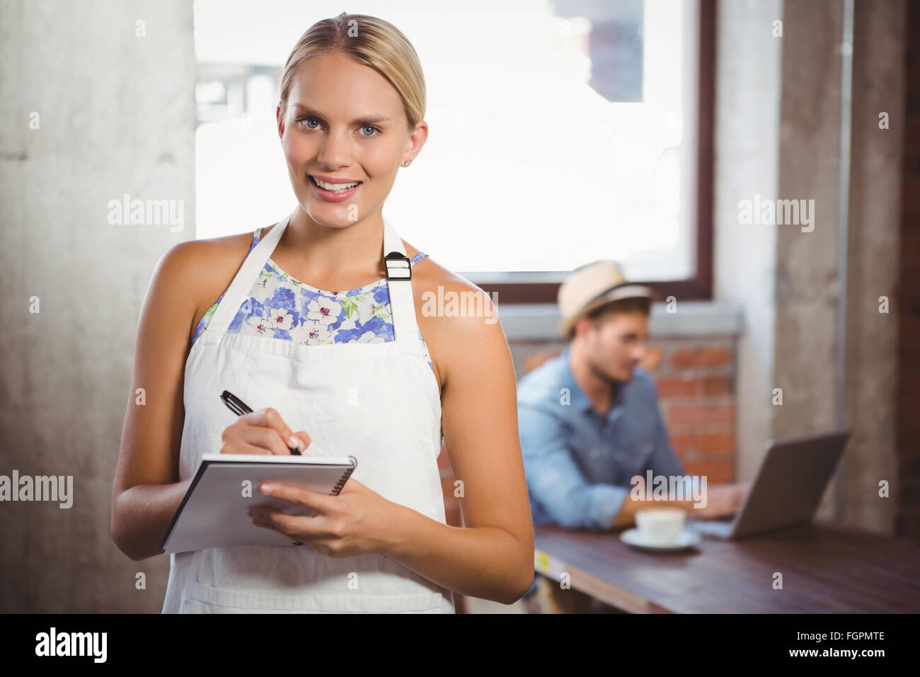 Smiling blonde waitress taking order in front of customer Stock Photo ...