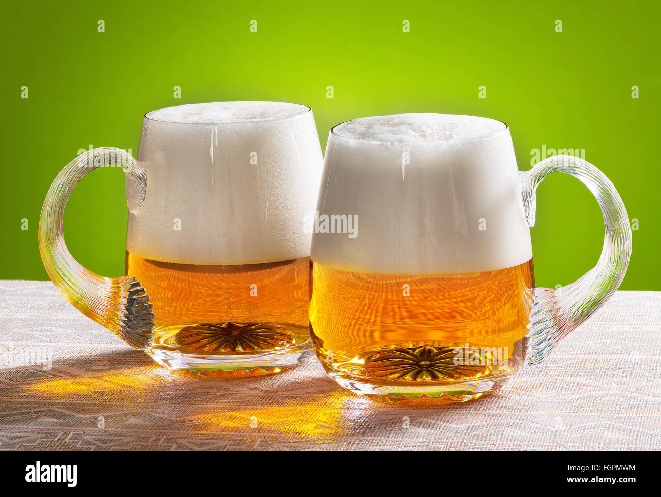 two beers on the table with green background Stock Photo - Alamy