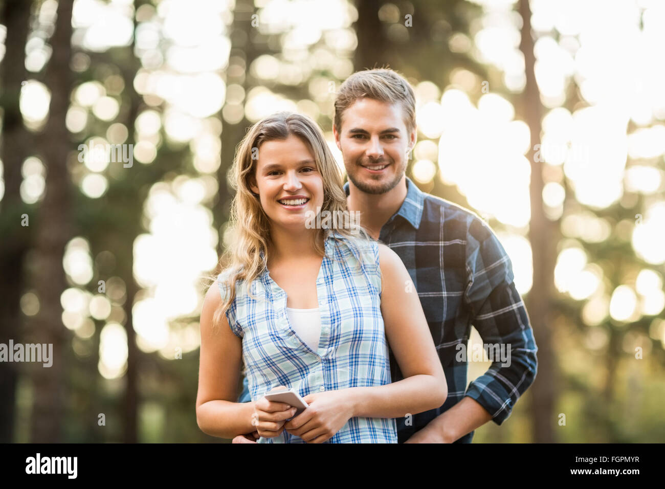 Happy smiling couple standing behind each other Stock Photo - Alamy