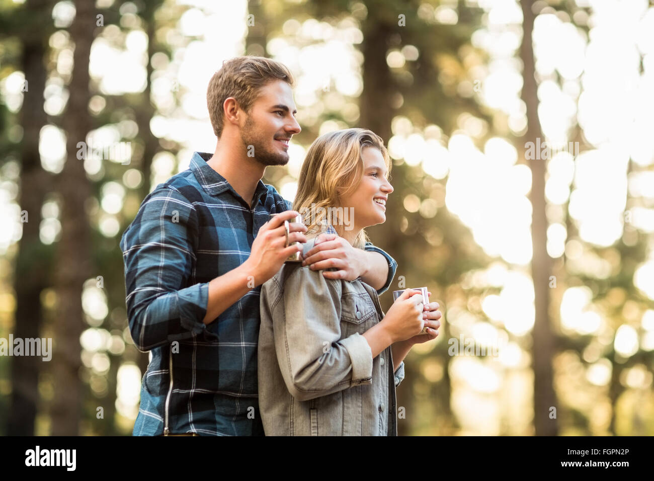 Happy smiling couple standing behind each other Stock Photo - Alamy