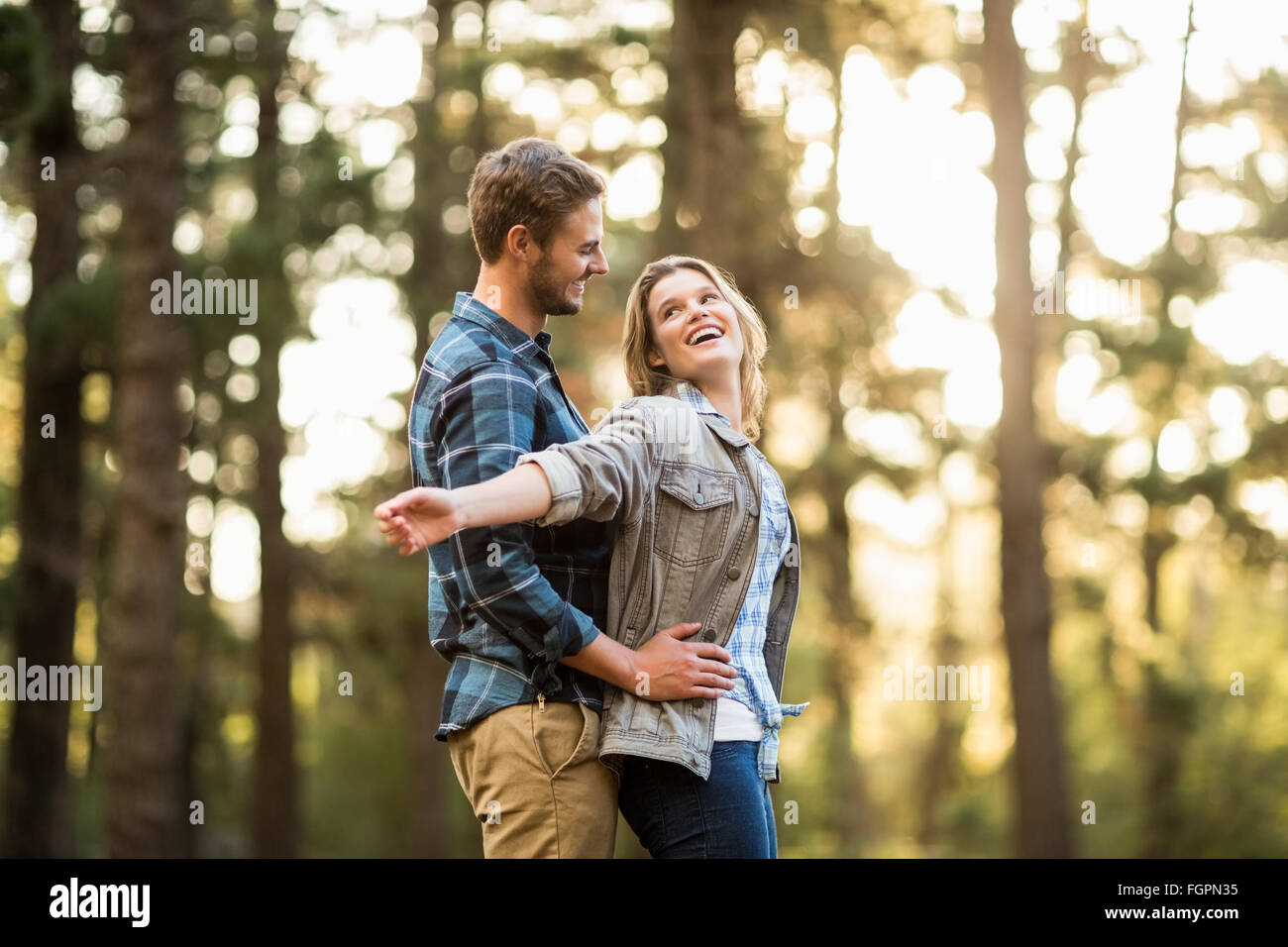 Happy smiling couple standing behind each other Stock Photo - Alamy