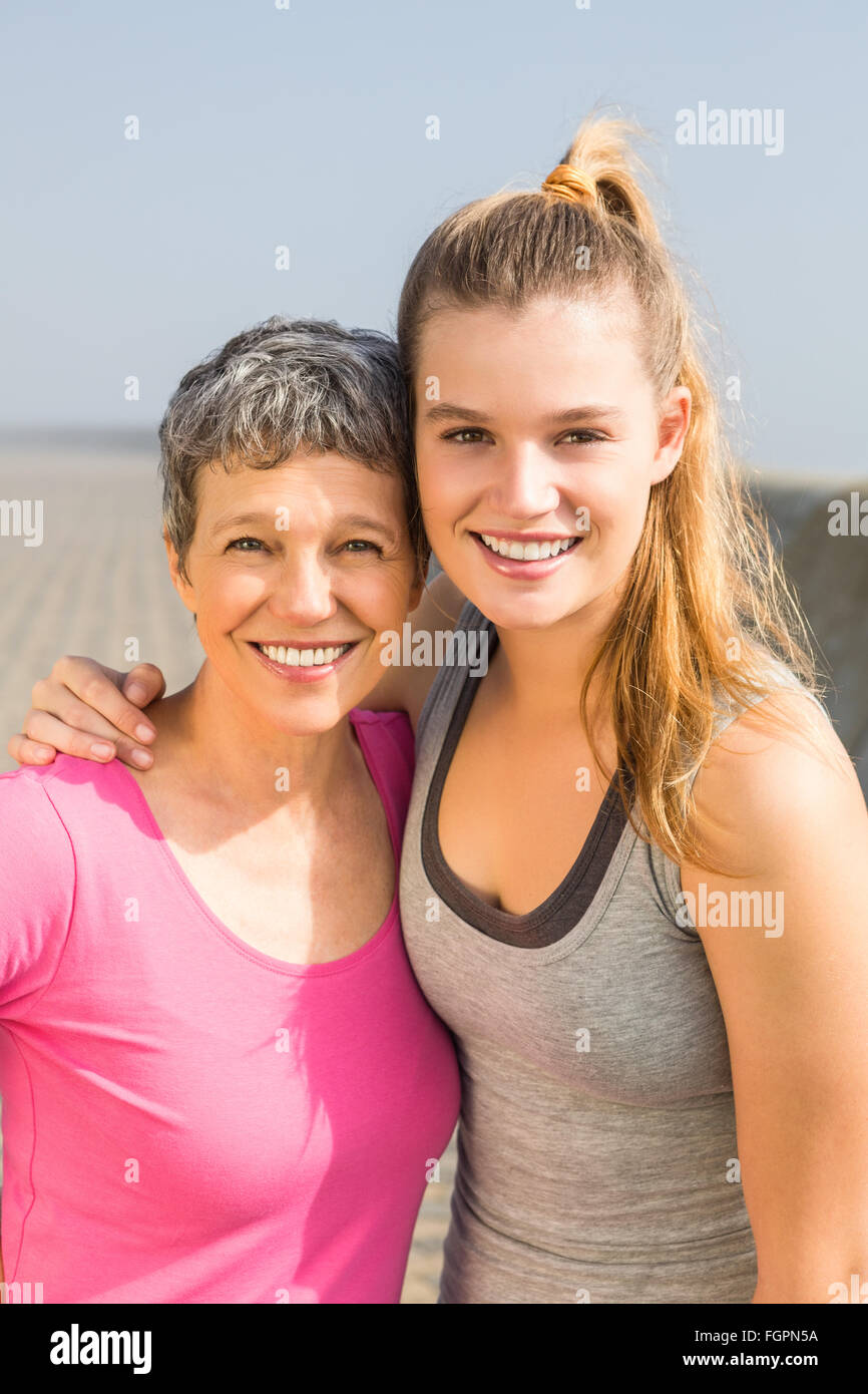 Sporty mother and daughter smiling Stock Photo - Alamy