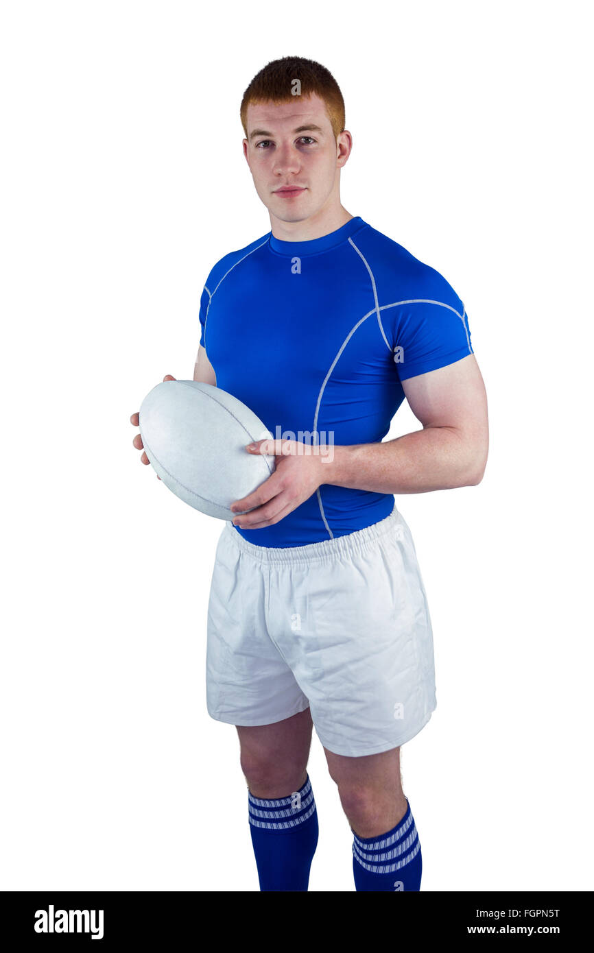 Smiling rugby player holding rugby ball Stock Photo - Alamy