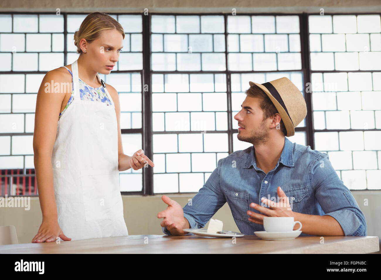 Argument between a waitress and a client Stock Photo - Alamy