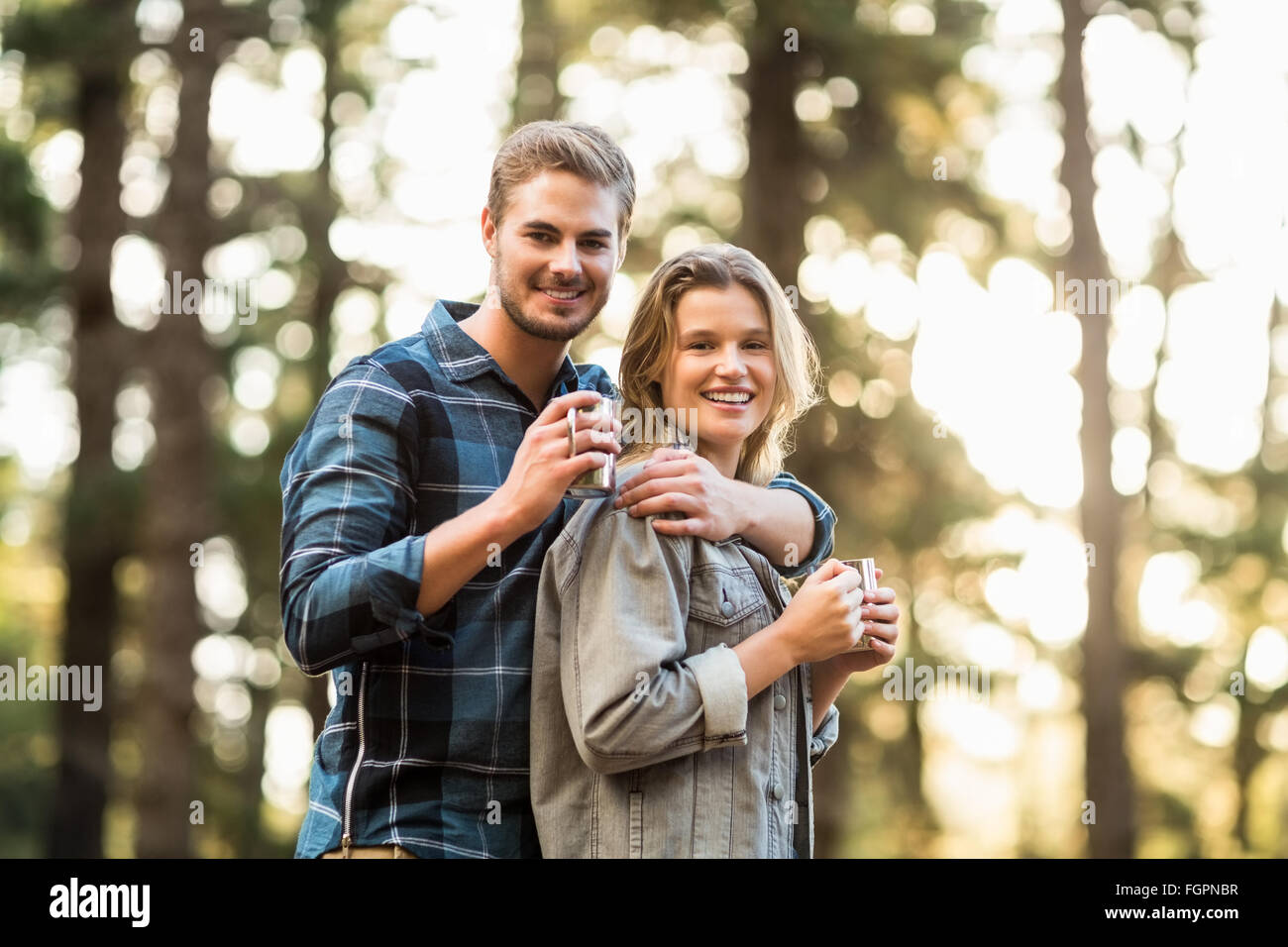 Happy smiling couple standing behind each other Stock Photo - Alamy