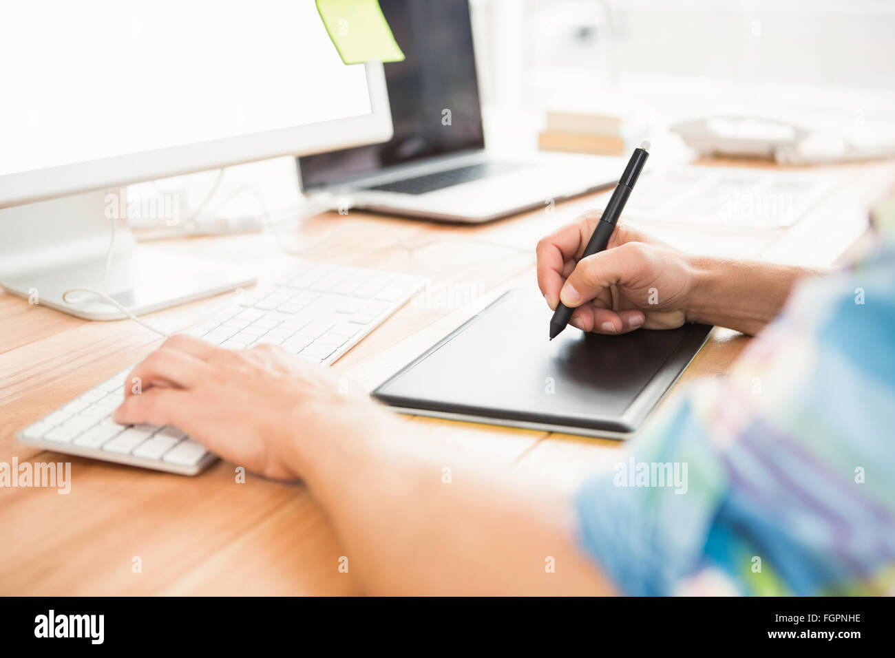 Graphic designer using computer and digitizer Stock Photo - Alamy