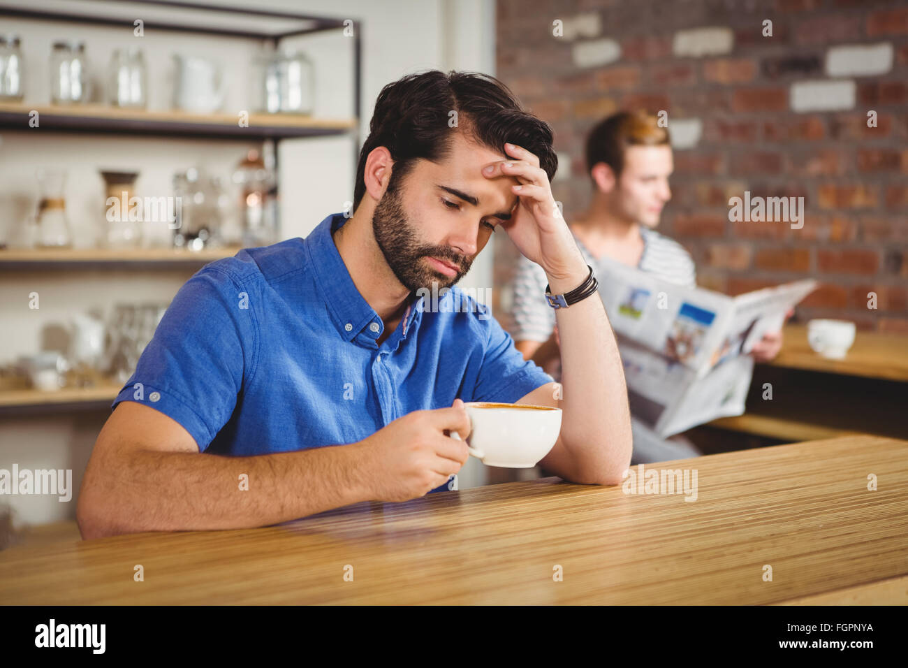 Worried man drinking a coffee Stock Photo - Alamy