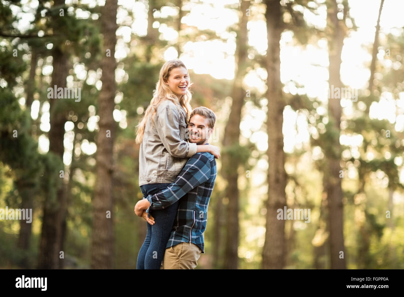 Smiling handsome man holding his girlfriend Stock Photo - Alamy