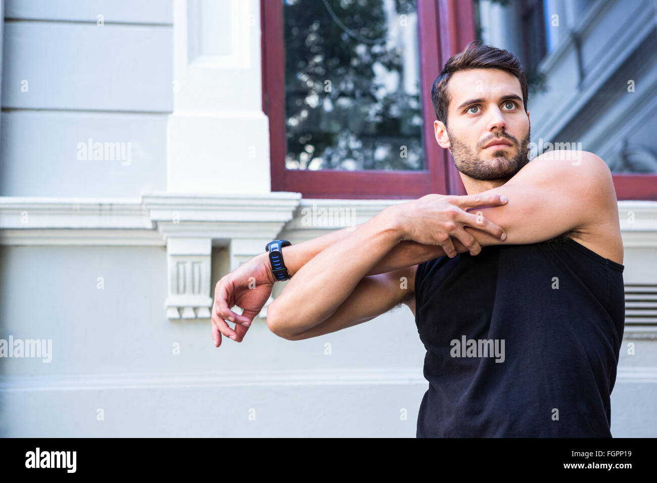 Handsome athlete stretching his arm Stock Photo - Alamy