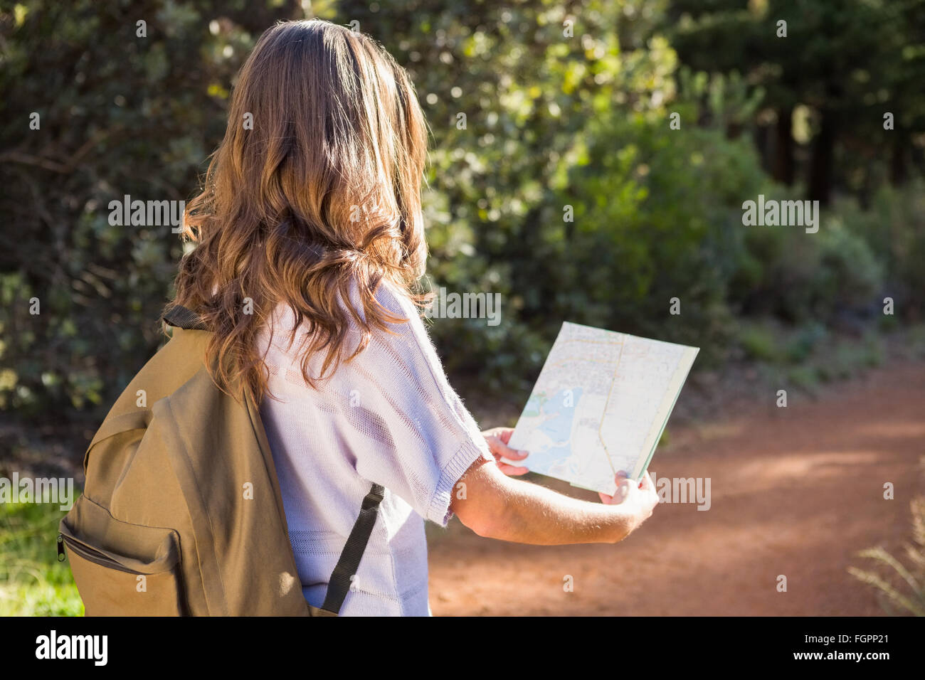 Brunette hiker reading map Stock Photo - Alamy
