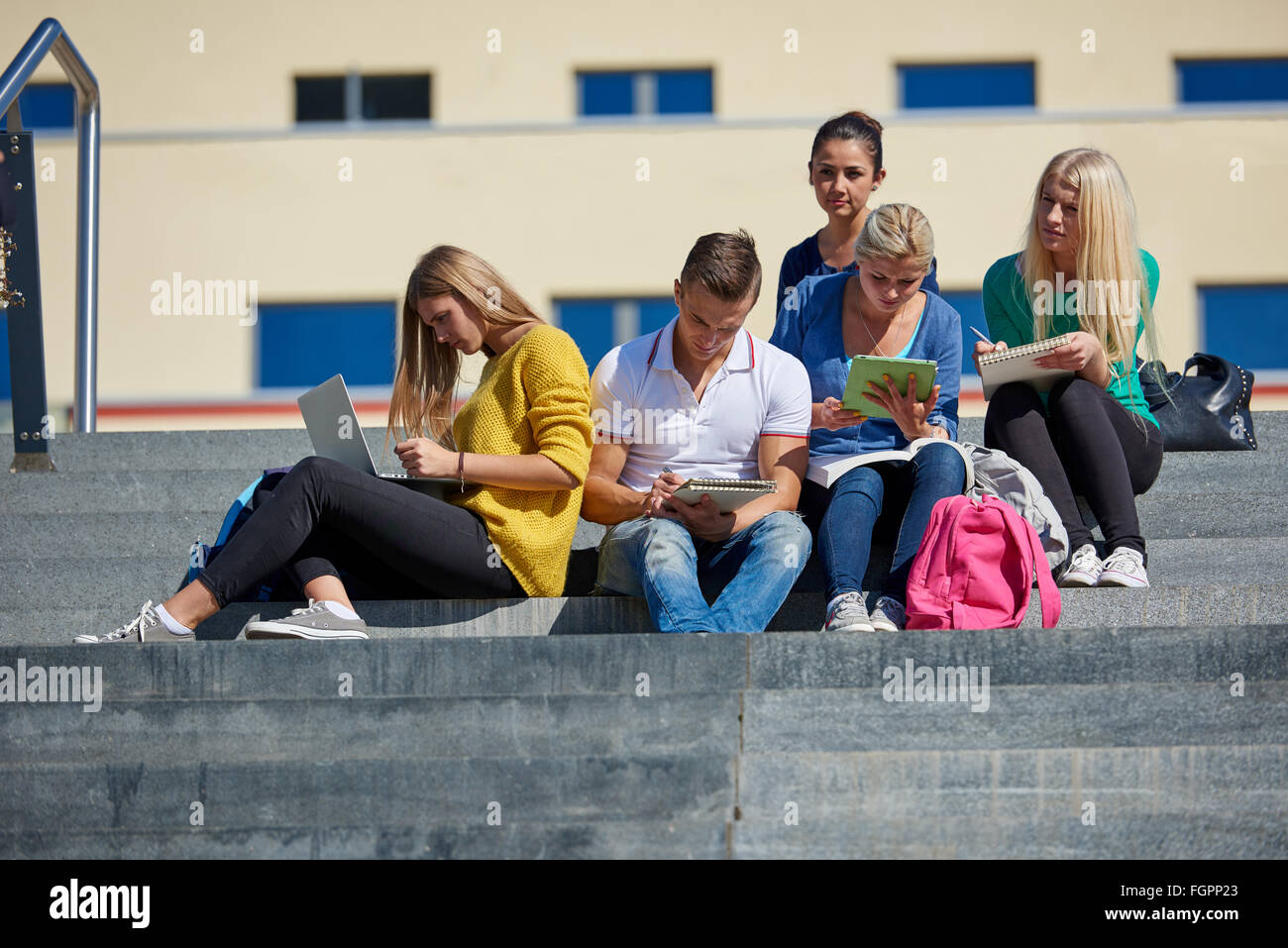 students outside sitting on steps Stock Photo - Alamy