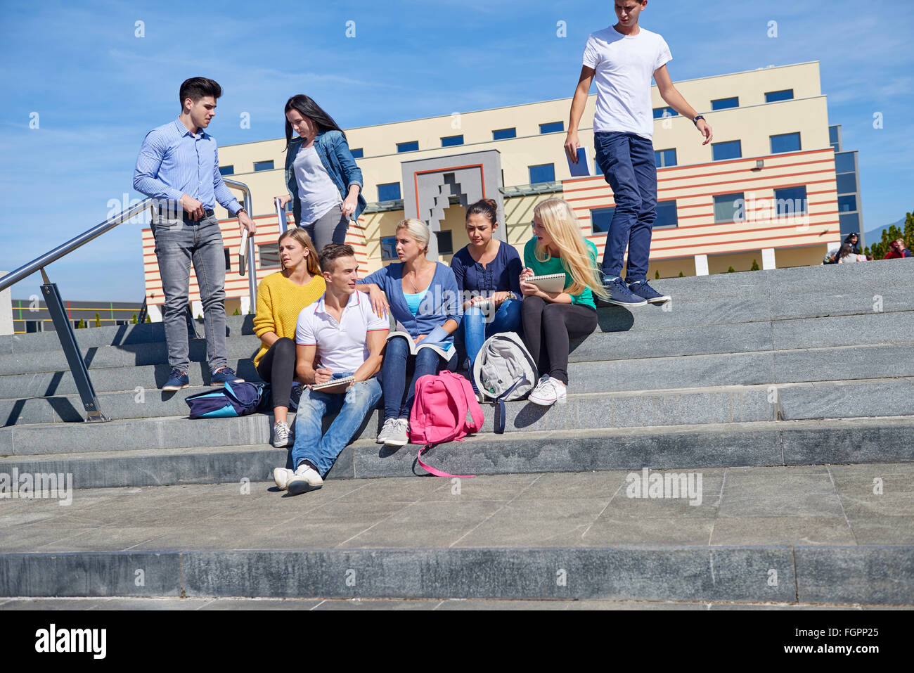 students outside sitting on steps Stock Photo - Alamy