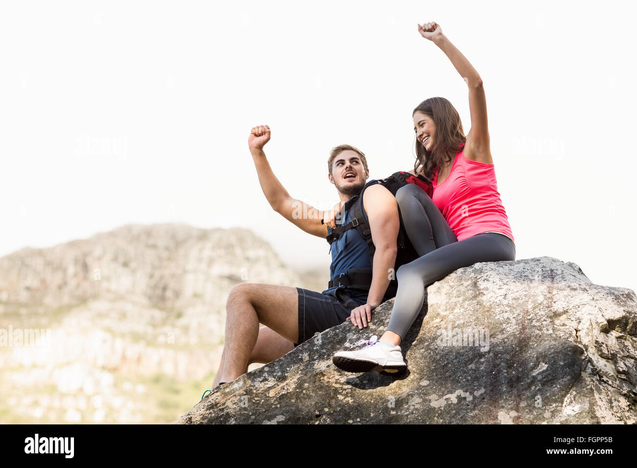 Young happy joggers sitting on rock cheering Stock Photo - Alamy
