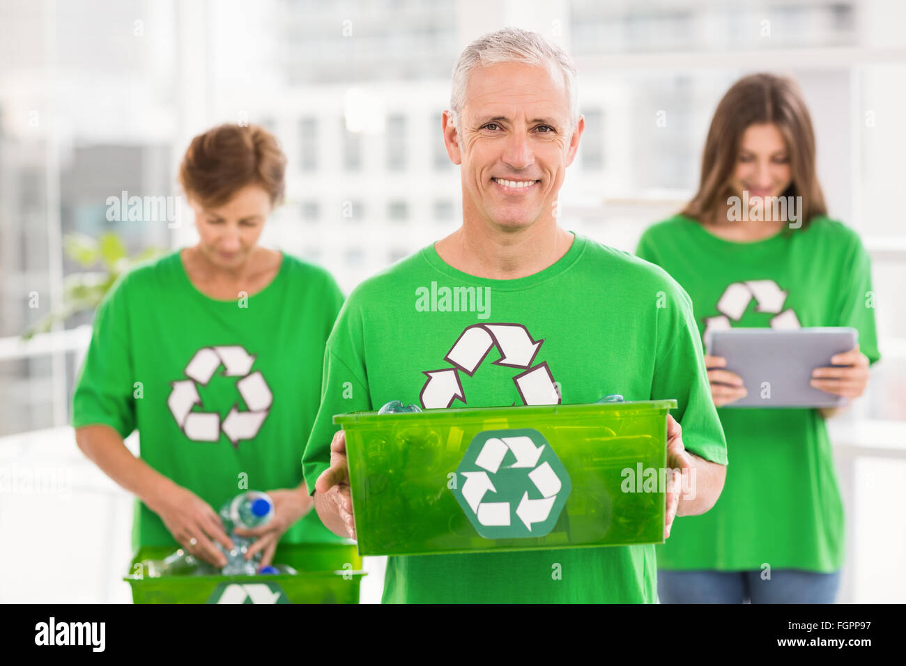 Smiling eco-minded man holding recycling box Stock Photo - Alamy