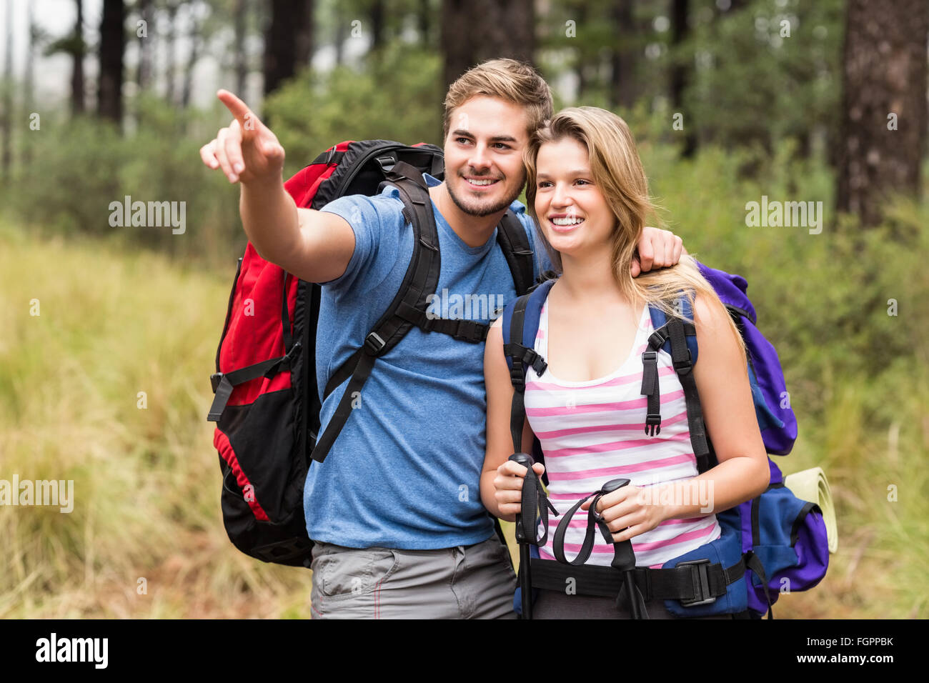 Young happy hiker couple pointing Stock Photo - Alamy