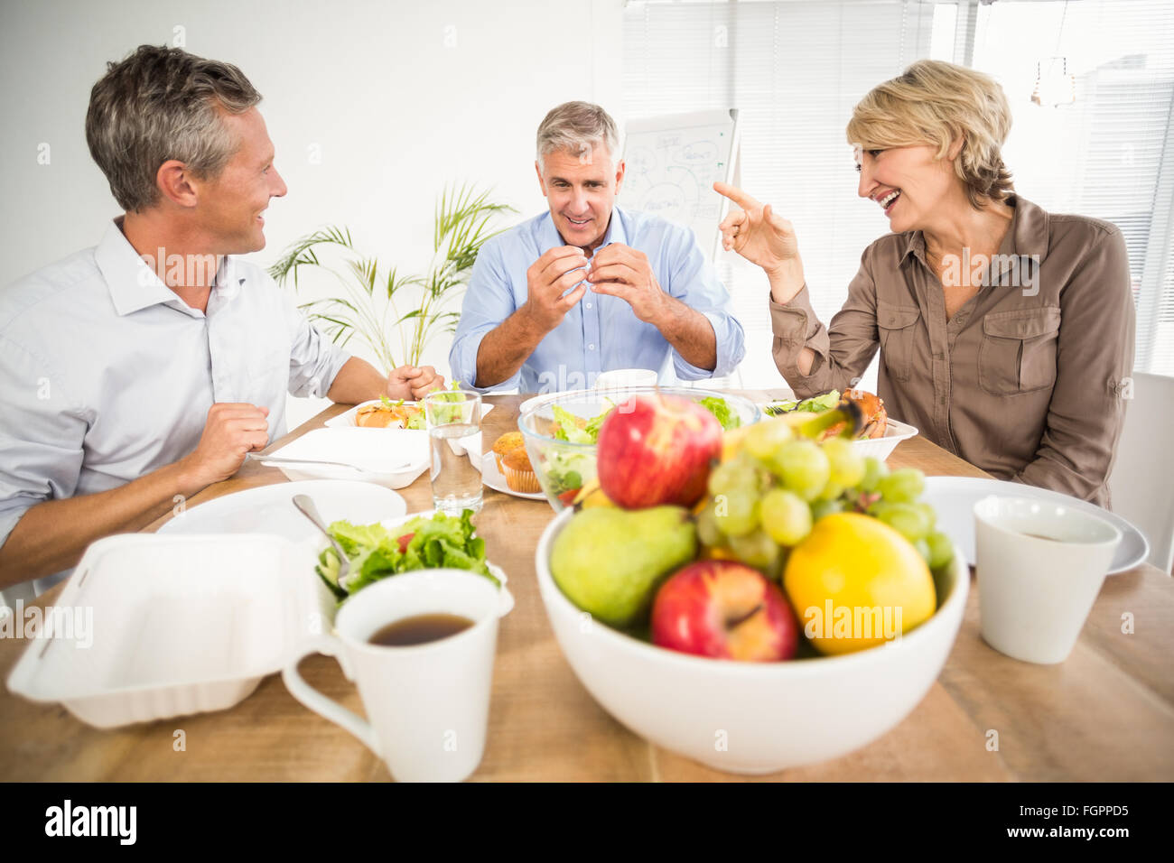 Smiling business colleagues having lunch together Stock Photo - Alamy