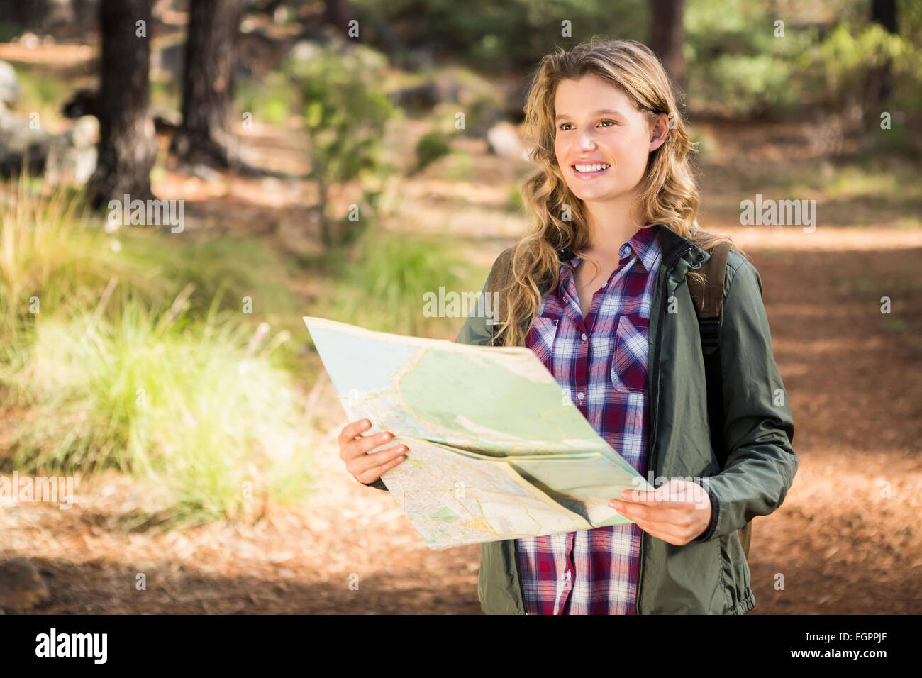 Pretty blonde hiker with map looking for path Stock Photo - Alamy
