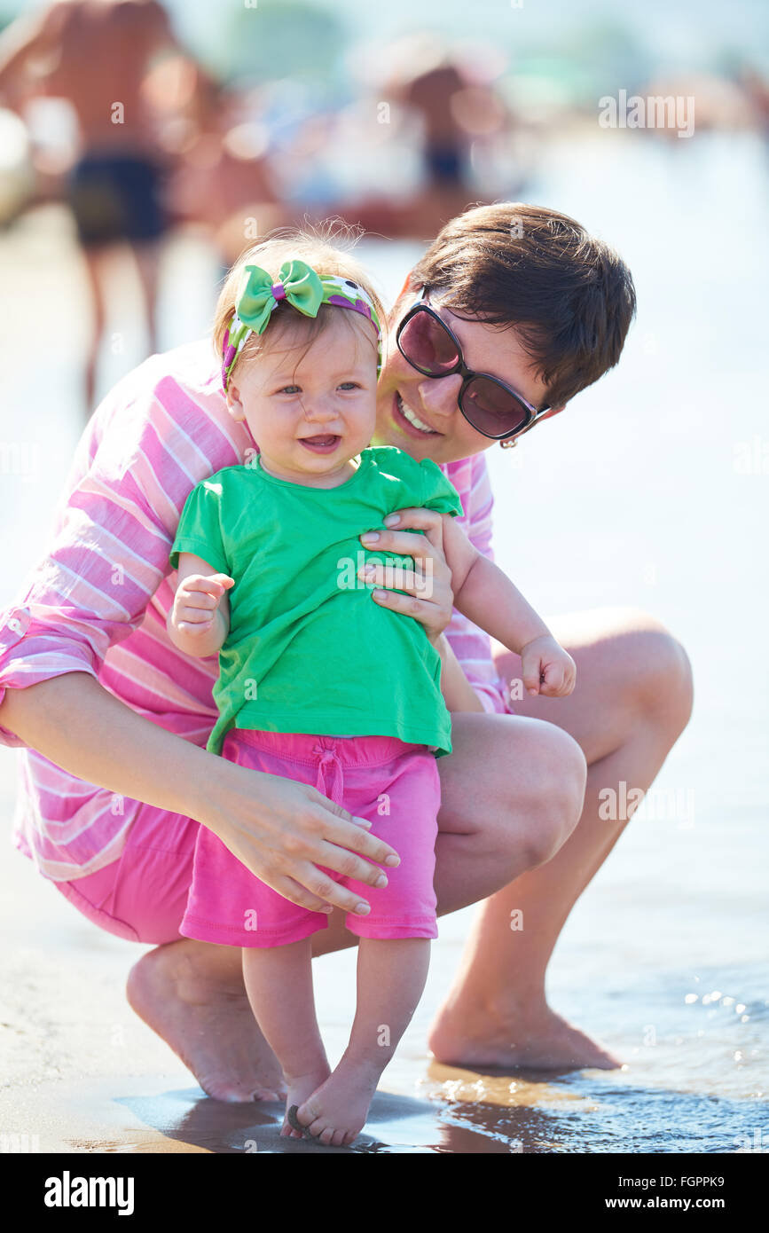 mom and baby on beach have fun Stock Photo - Alamy