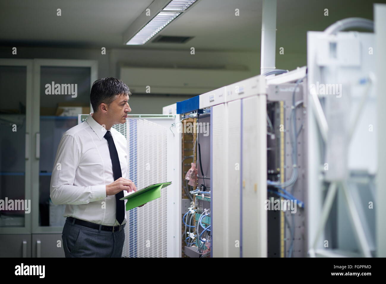 network engineer working in server room Stock Photo - Alamy