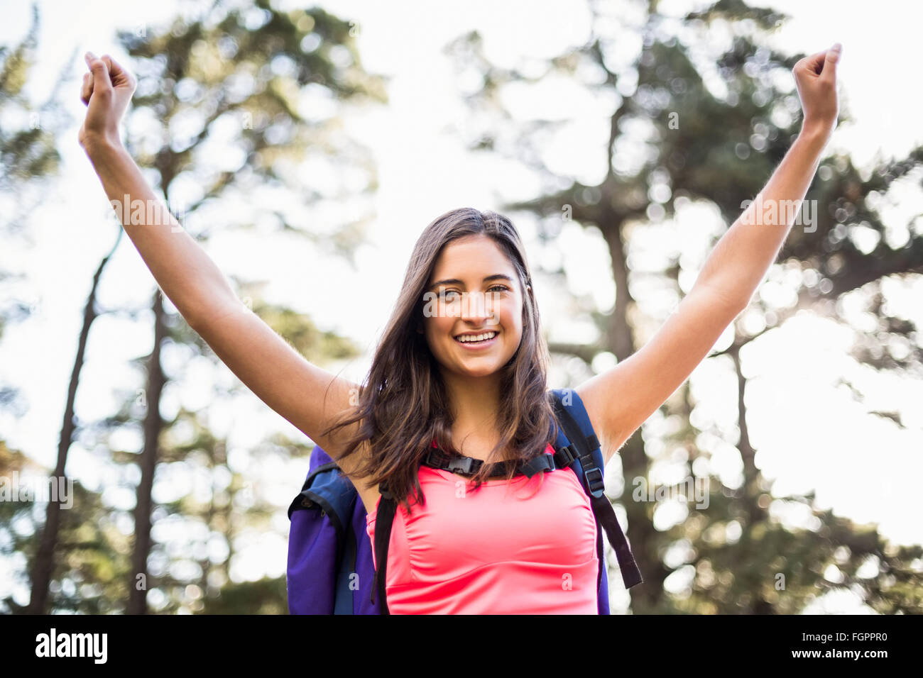 Young happy jogger sitting on rock and cheering Stock Photo - Alamy
